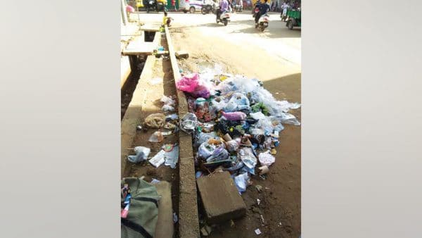 Plea to clear garbage dumped near bus stop at Hebbal - Star of Mysore