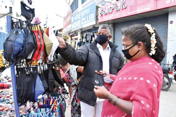 Losing jobs to COVID pandemic, people sell face masks to survive - Star ...