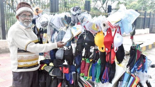 Losing jobs to COVID pandemic, people sell face masks to survive - Star ...